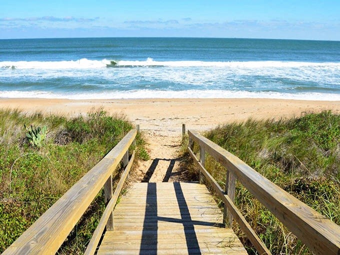 Wooden walkways invite beach explorers down to Vilano's shoreline, where the Atlantic's waves create a surfer's playground just minutes from historic St. Augustine.