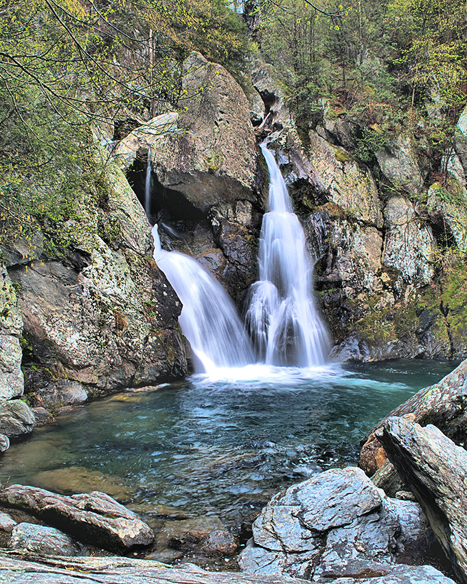 Bash Bish Falls cascades dramatically between moss-covered rocks. Nature's own water feature puts any human-made fountain to shame!