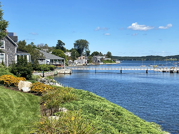 Castine's waterfront showcases classic New England coastal beauty with its blue waters, green lawns, and charming harbor views.