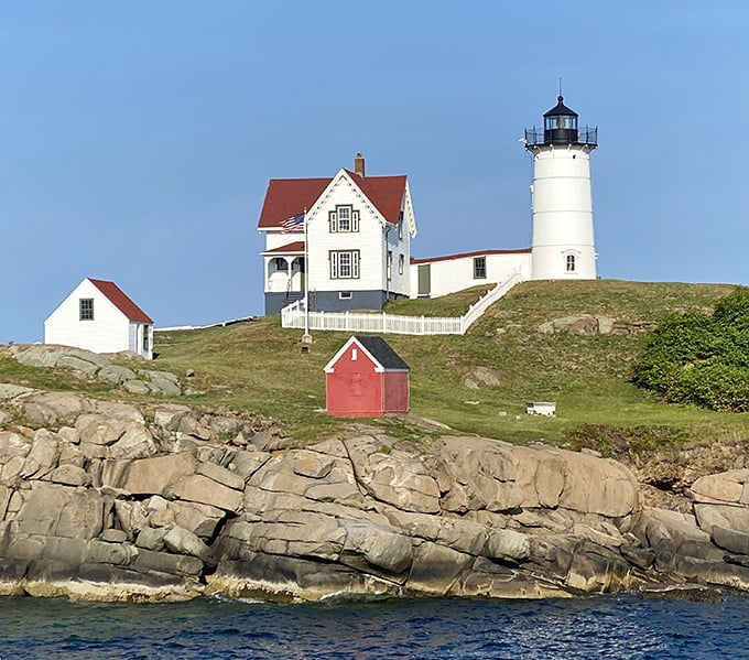 Nubble Light creates the classic lighthouse postcard view, its white tower and keeper's house perched perfectly on a tiny rocky island.