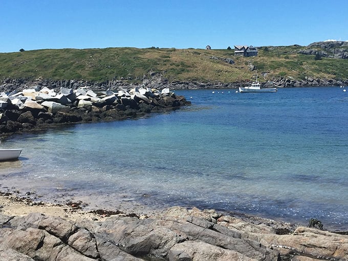 Rocky outcroppings frame the crystal-clear waters of Monhegan Island, where sea glass hunters discover colorful prizes among the stone