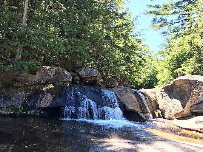 Screw Auger Falls carves its way through golden bedrock, creating swirling patterns that hypnotize visitors.