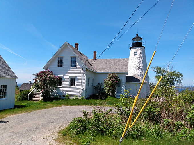 A white lighthouse keeper's home stands watch over Castine's waters, its weathered charm telling tales of maritime history.