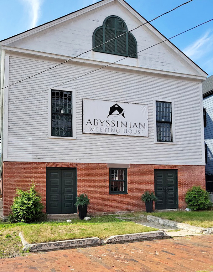 A closer view of the Abyssinian Meeting House showing its restored facade and prominent sign, marking this important stop on the Underground Railroad.
