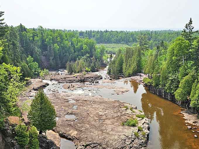 Multiple tiers of falling water create nature's perfect staircase at Gooseberry Falls, where visitors gather to feel the refreshing mist.