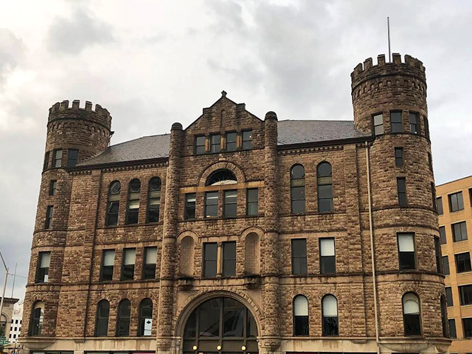 The GAR Building's distinctive castle silhouette stands as a historical landmark in downtown Detroit, its weathered stone telling stories of generations past.