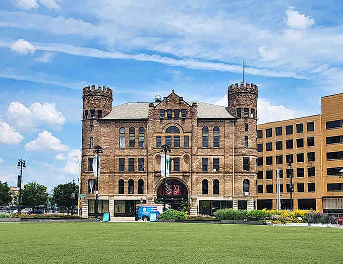 The castle-like structure seems to whisper tales of Detroit's past, its stone facade glowing warmly in the Michigan sunshine.