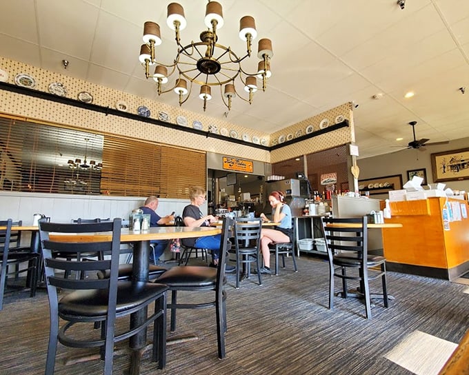 Inside Grandma's Kitchen, vintage charm meets comfort food paradise with decorative plates lining the walls and tables ready for pie enthusiasts.