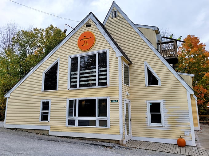 The unique yellow A-frame architecture of IPIE Pizzeria makes it stand out against Killington's natural beauty.
