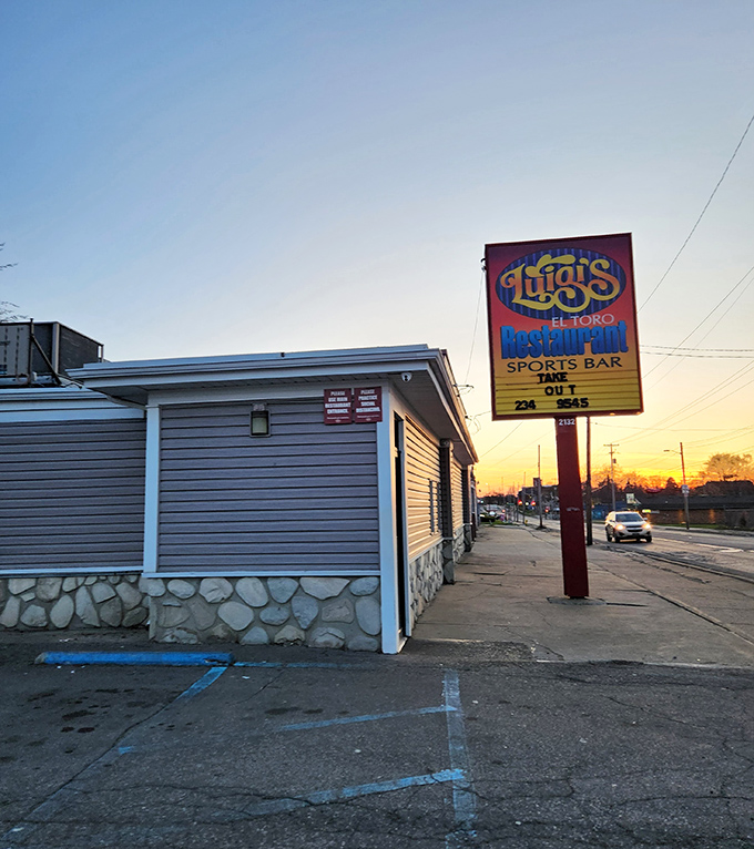 Luigi's El-Toro sign glows at sunset, marking this sports bar and pizzeria that's been satisfying Flint's cravings for generations.