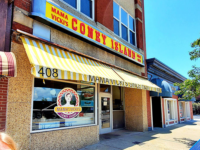 Mama Vicki's cheerful yellow awning has been a beacon for Coney lovers in Port Huron since 1921, serving up Michigan classics with a smile.