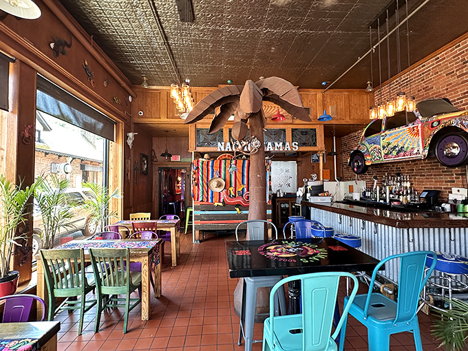 Step inside Nacho Mama's to discover a vibrant interior with wooden accents, colorful tables, and quirky beach-themed decorations that set the stage for taco perfection.