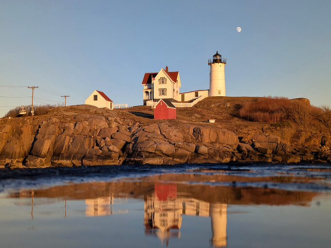 As the sun dips below the horizon, Nubble Light's silhouette stands against a painted sky, ready to guide ships through the night.