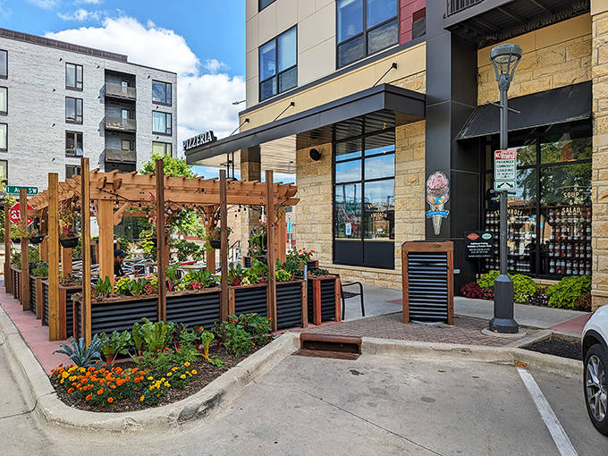 A welcoming aura surrounds Pasquale's Neighborhood Pizzeria's inviting entrance, where wooden planters and outdoor tables welcome hungry visitors.