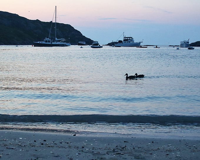 Boats dot the peaceful harbor at Monhegan Island, where generations of maritime activity have contributed to the sea glass bounty on its shores. 