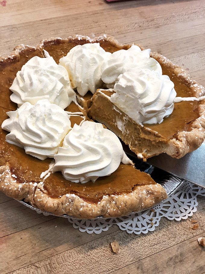 Pumpkin pie elevated to art form &ndash; silky filling crowned with pillowy whipped cream rosettes that make every bite a celebration.