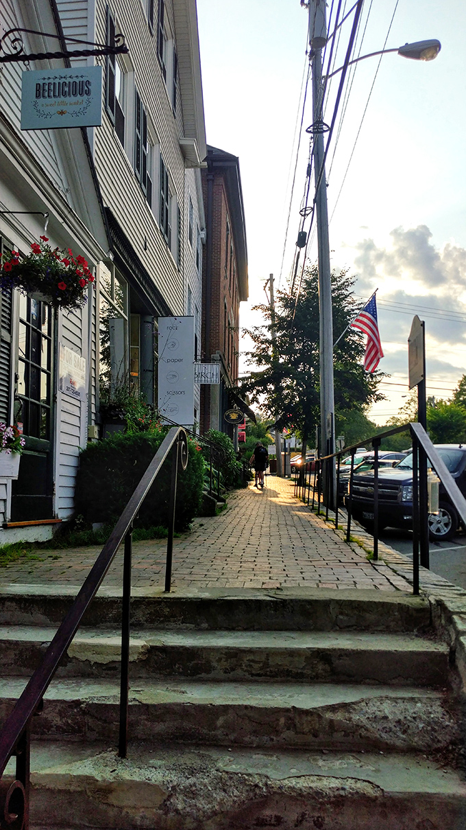 The warm glow of sunset bathes Wiscasset's waterfront buildings, creating a golden reflection that transforms everyday structures into something magical.
