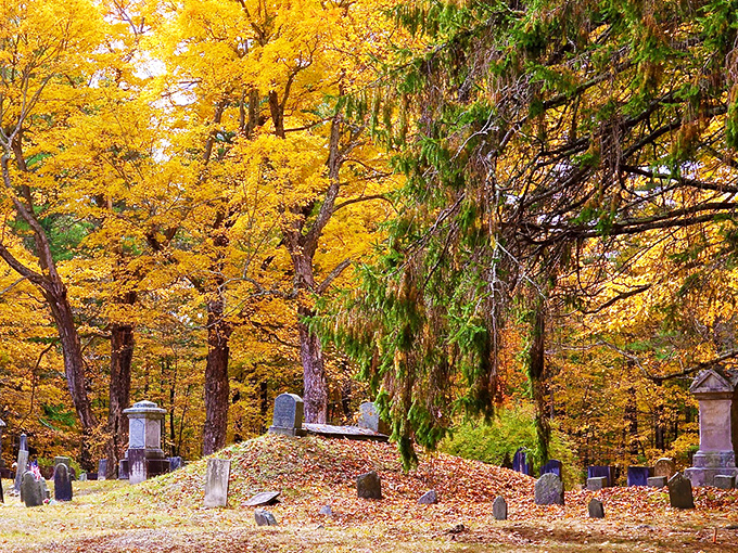 Autumn transforms this ancient burial ground into a canvas of golden light, where fallen leaves create nature's tribute to generations past.