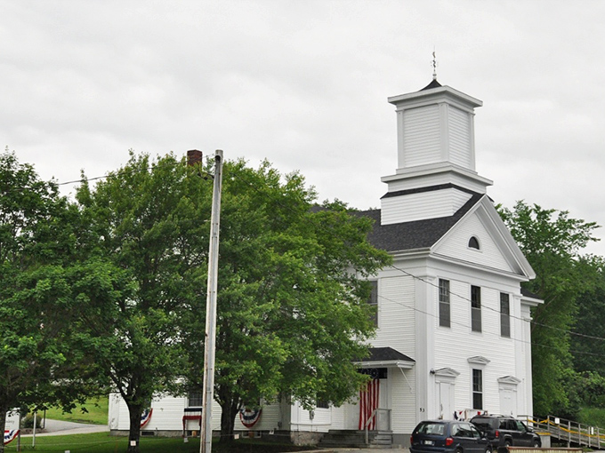 The Cherryfield Academy building stands proud, its white clapboard and steeple a testament to New England architectural tradition.