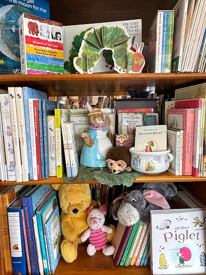 The Very Hungry Caterpillar and friends create a colorful haven where childhood classics nestle between stuffed companions, waiting for little hands.