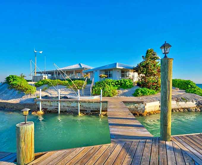 A wooden dock stretches like a welcome mat to your private island retreat, promising adventure with every step.