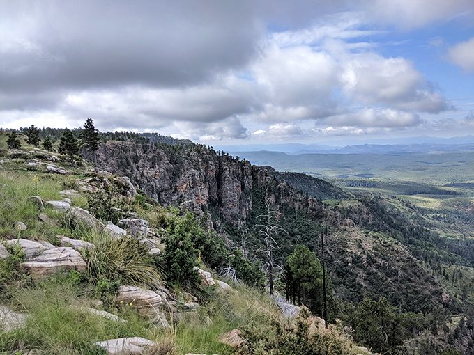 Clouds play hide-and-seek with the landscape below, creating an otherworldly experience that feels more like flying than driving.