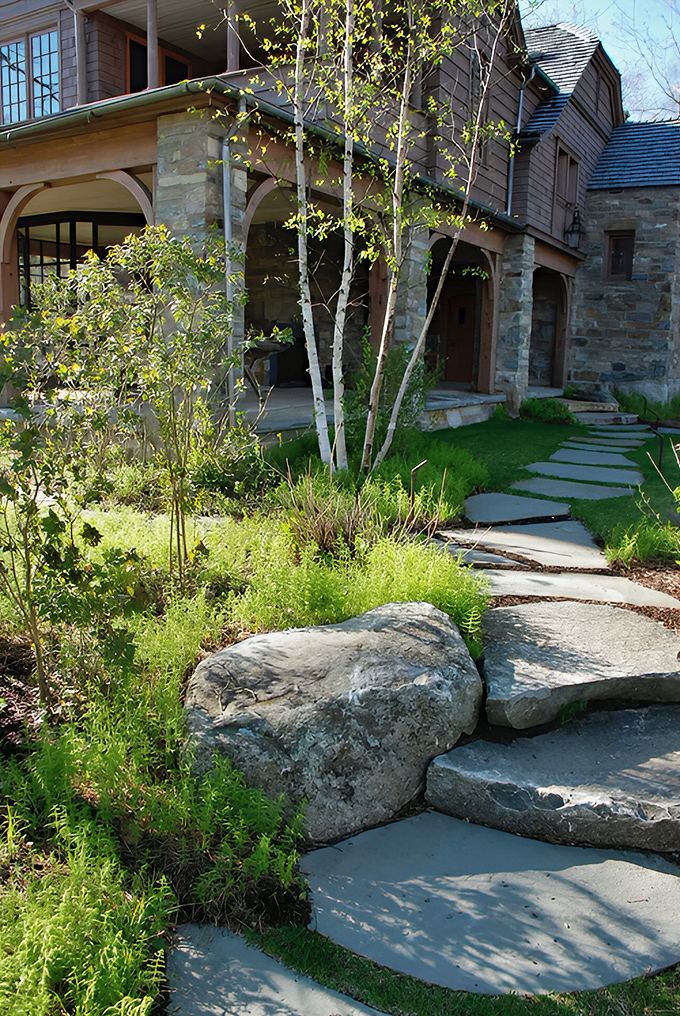 Each stone step invites a mindful journey through lush greenery, creating anticipation for the luxury that awaits.