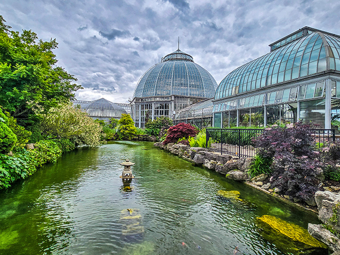 The Anna Scripps Whitcomb Conservatory's crystal dome rises like a botanical spaceship, neighboring the aquarium in perfect architectural harmony.