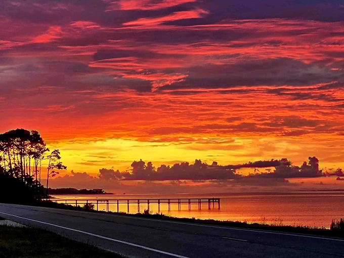 Mother Nature's light show: sunset transforms the coastal bridge into a silhouette against a blazing Florida sky.