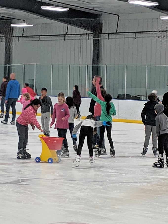 Learning to glide with style! Young skaters find their balance while instructors offer guidance and those magical push-carts provide confidence.
