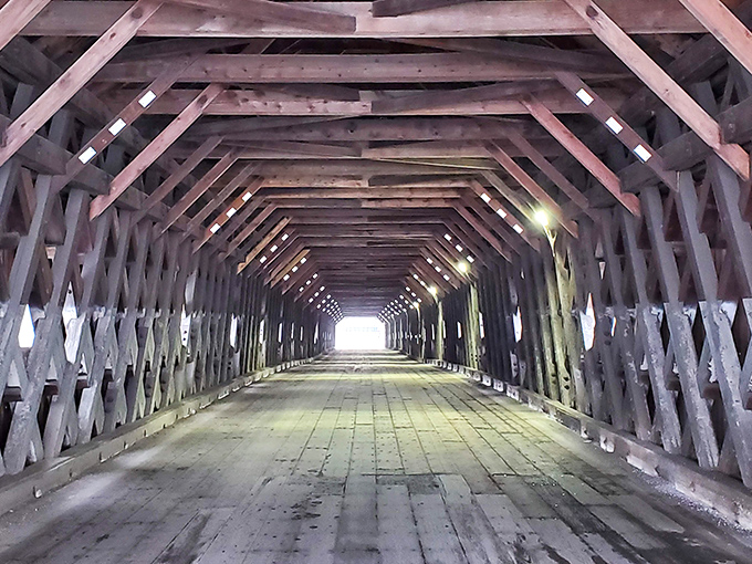 Sunlight filters through latticed beams inside the bridge, creating a cathedral-like atmosphere that's both serene and spectacular.