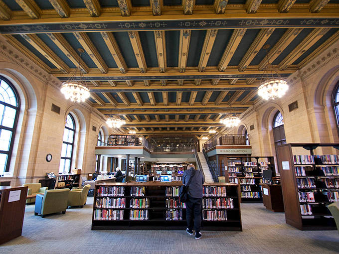 Soaring ceilings, elegant columns, and warm lighting create a cathedral-like atmosphere where books are worshipped and silence is sacred.