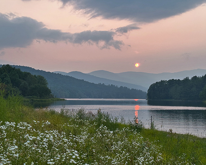 Sunset paints the reservoir in watercolor hues, transforming an already beautiful scene into something that belongs in a museum &ndash; if museums could capture magic.