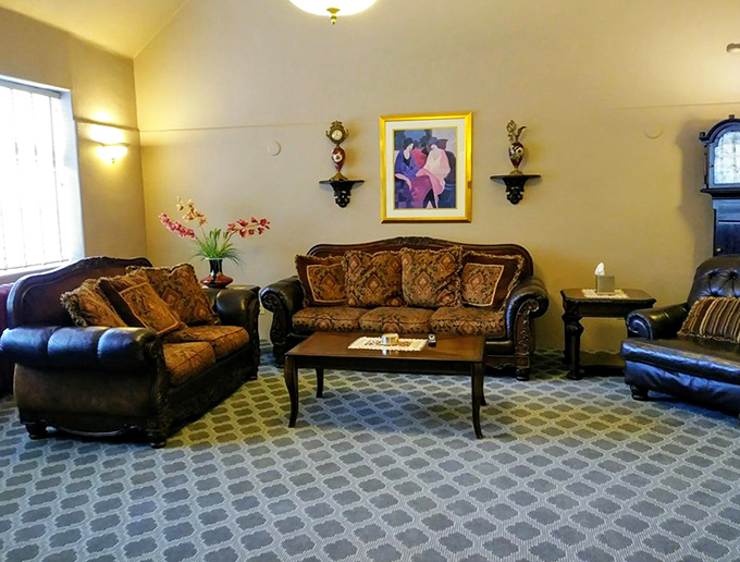 The living room's elegant furnishings invite relaxation, though some guests swear the indentations on that sofa aren't always made by the living.