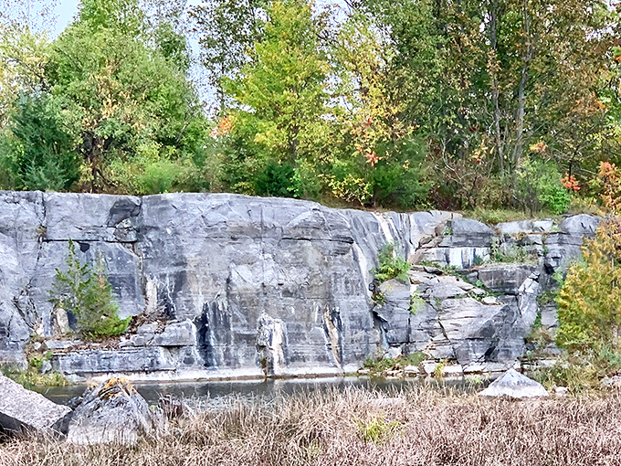 Limestone cliffs stand as silent witnesses to Earth's ancient past, carved by time and human hands.
