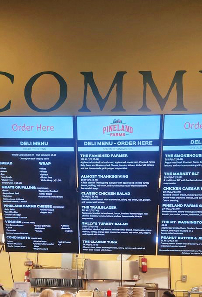 Decisions, decisions! The menu board tempts with farm-fresh creations like "The Famished Farmer" and "Almost Thanksgiving" – each a masterpiece between bread.