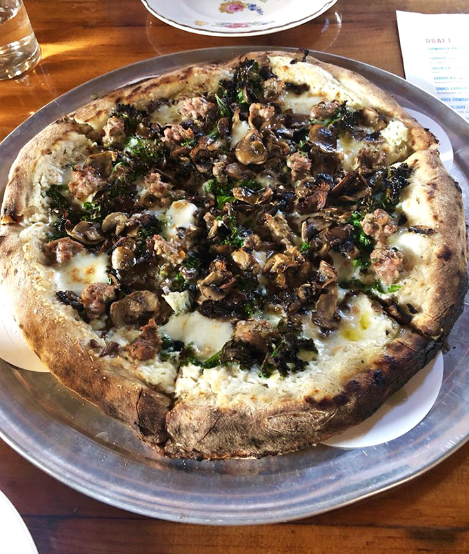 This isn't just pizza &ndash; it's a wood-fired masterpiece of foraged mushrooms, melted cheese, and herbs that might make you reconsider your life choices.
