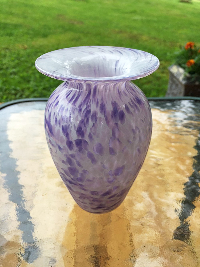 This delicate purple vase showcases the ethereal beauty possible when skilled hands meet molten glass &ndash; each swirl tells a story.