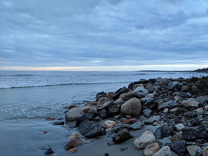 Rocky sentinels guard the shoreline, witnesses to centuries of tides, storms, and shipwrecked dreams.