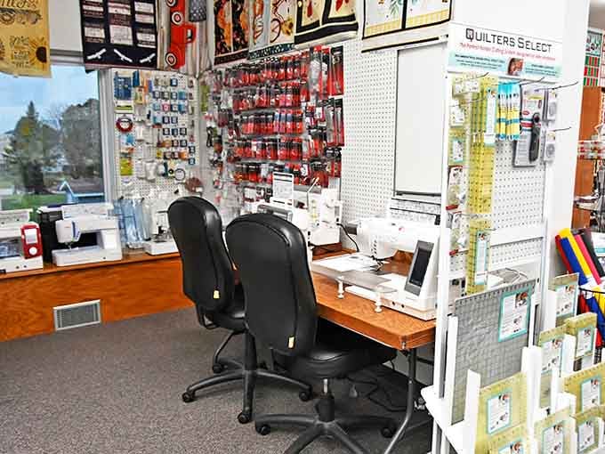 The sewing station awaits with machines ready for action &ndash; where fabric dreams become stitched reality.