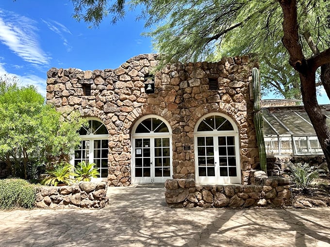 Stone architecture meets desert flora at the historic Smith Building, where rustic charm blends seamlessly with natural beauty.