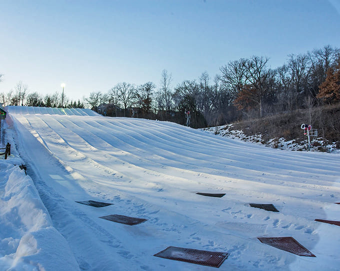 The tubing area gleams under winter skies, promising the kind of thrills that make you forget about your heating bill.