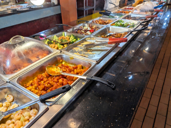 Steam rises from freshly replenished trays, showcasing the buffet's commitment to serving food at its prime rather than languishing under heat lamps.