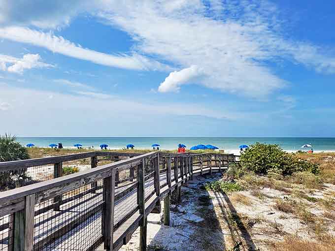 The path less traveled: A weathered wooden boardwalk guides beach-goers through natural dunes, preserving the fragile ecosystem while delivering you to shoreline bliss.