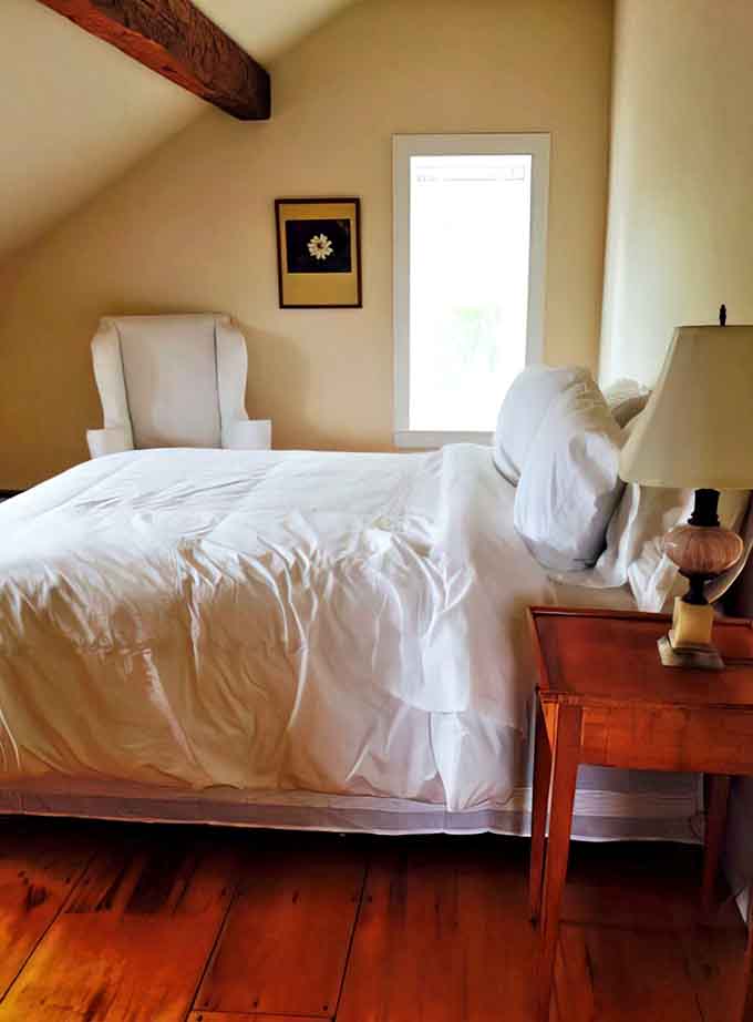 Sweet dreams come naturally in this serene bedroom, where exposed beams and crisp white linens create the perfect balance of rustic charm and modern comfort.