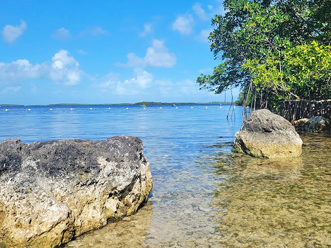 Ancient limestone sentinels stand guard at the shoreline, witnesses to centuries of tides and countless sunset admirers.