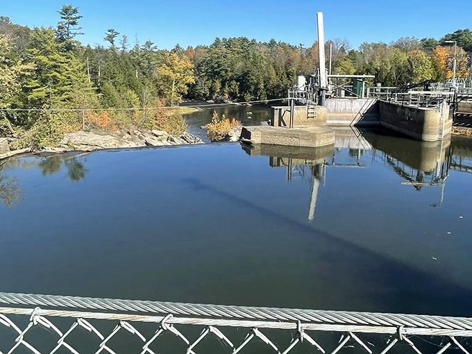 Industrial meets natural beauty at the dam, where Otter Creek's rushing waters create a mirror-like stillness perfect for reflection.
