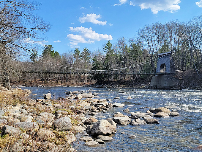 From a distance, the suspension bridge appears almost delicate against Maine's rugged landscape, a testament to engineering that stands the test of time.