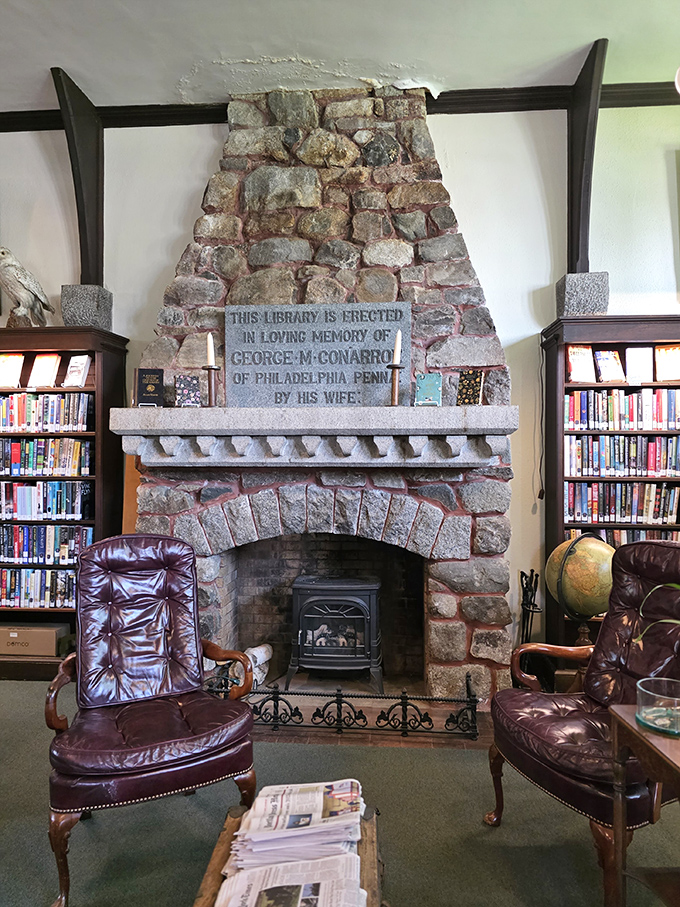 "This library is erected in loving memory of George M. Conarroe" - the magnificent stone fireplace serves as both functional hearth and historical monument.