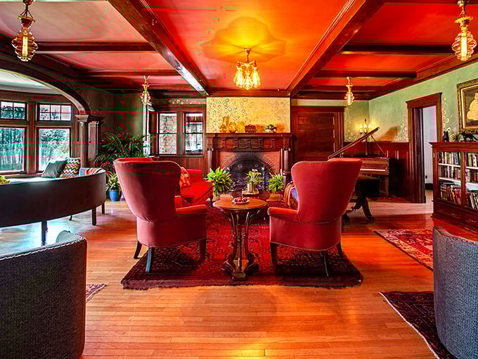 The living room's dramatic red ceiling and cozy fireplace create the perfect spot for swapping tales of underground adventures.